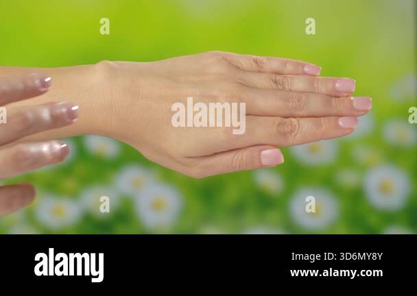 Finger applying moisturizing cream to hand, showing smooth skin and a ...