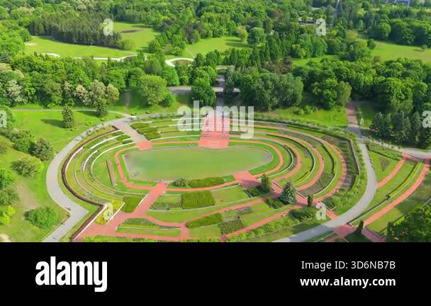 Geometric amphitheater with concentric terraces surrounding pond ...