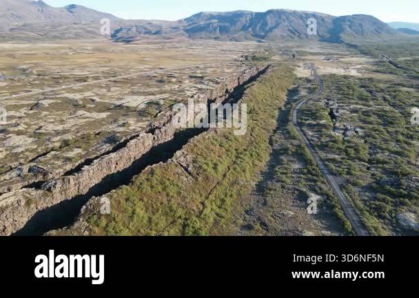 Icelandic Plate Fault. A large canyon with a mountain in the background ...