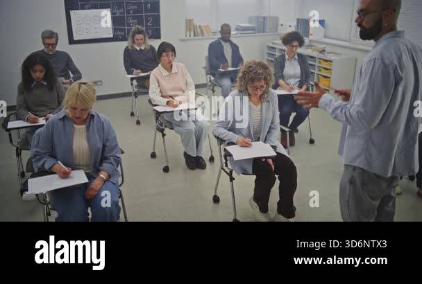 Diverse Group Adult Students Attending Class, Focused on Writing ...