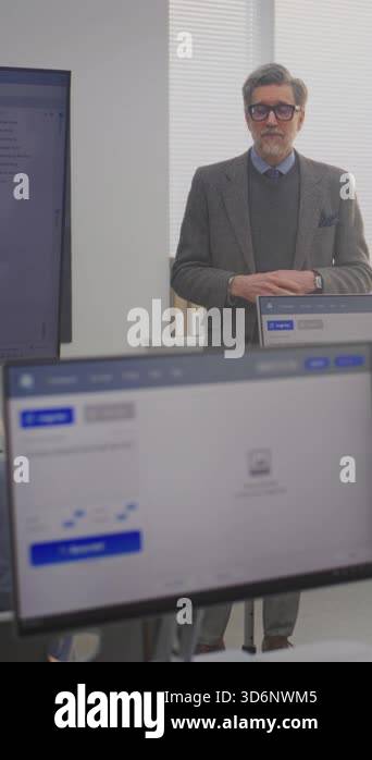 Stylish Male Instructor Stands by Monitor Showing Program, Explaining AI Generation Principles ...