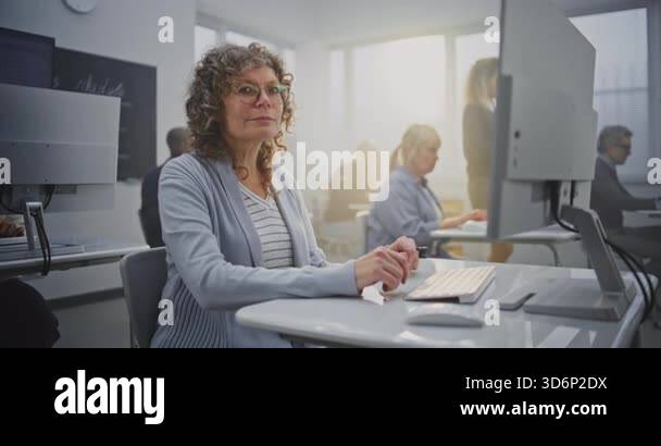 Cheerful Middle Aged Woman With Curly Graying Hair Studies Coding on ...