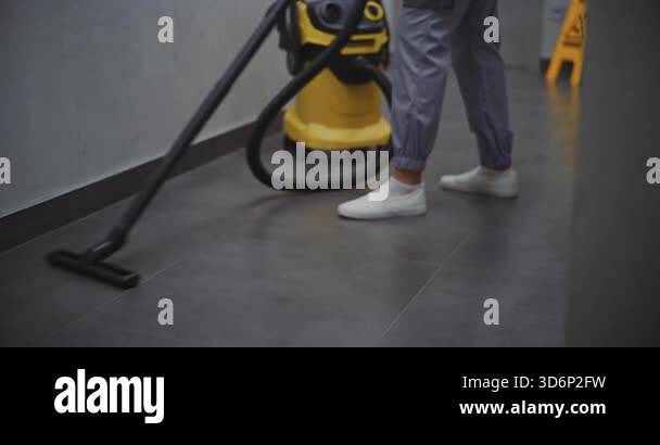 Hotel Housekeeper Vacuuming Hallway. Uniformed Maid Cleaning Hotel ...