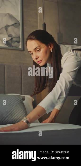 Housekeeping Woman Employee in Uniform Adjusts Bedding and Pillow ...