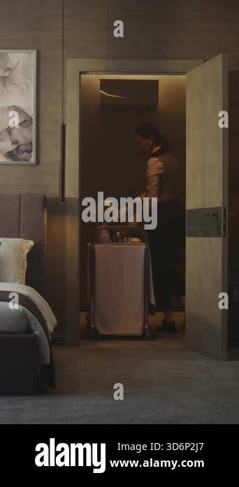 Hotel Maid Entering Elegant Hotel Room With Breakfast Trolley. in Cozy ...