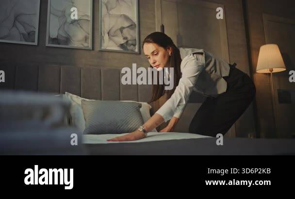 Housekeeping Woman Employee in Uniform Adjusts Bedding and Pillow ...