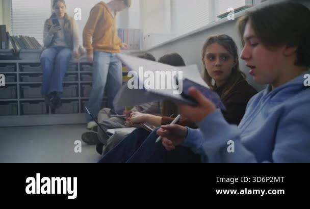 Young Students Gather on Floor, Engaged in Active Discussion and Note ...