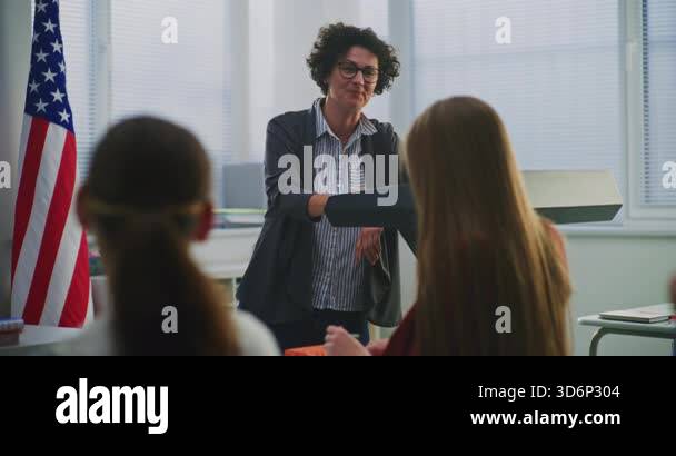 American Teacher Stands Podium Beside US Flag, Engaging Students In ...