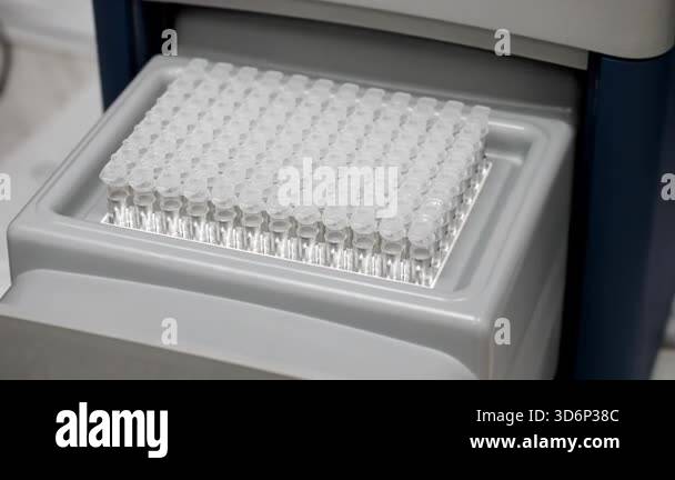 Close up of PCR thermal cycler closing with tray of microtubes in ...