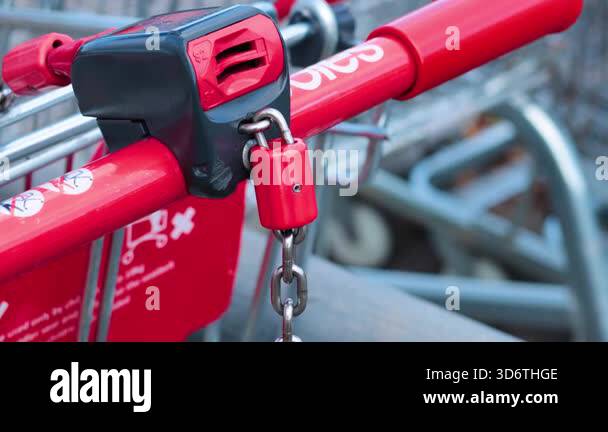 Coin lock mechanism on shopping trolleys Stock Video Footage - Alamy