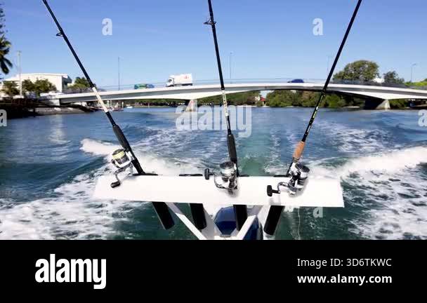 Fishing rods on boat moving under bridge Stock Video Footage - Alamy
