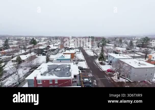 cinematic snowy view of Canadian suburban neighborhood with cold air ...