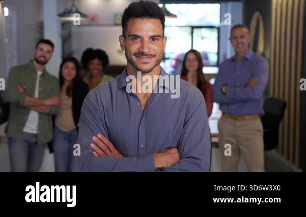 Confident Latin American businessman standing with arms crossed at ...
