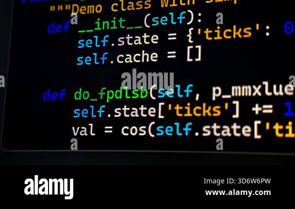 Closeup view of a computer monitor showing programming code on a dark background as someone ...