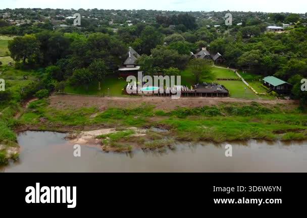 riverside safari lodge with pool aerial drone view of secluded thatched ...