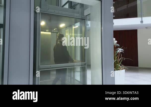 Young girl riding in a modern elevator, showcasing her journey as the ...