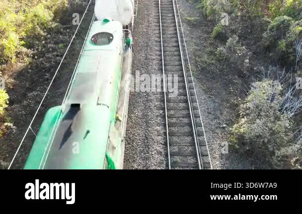 Railway freight train moves along tracks, showcasing continuous motion ...