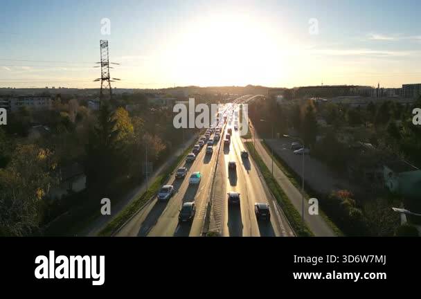 Aerial view of busy highway during golden hour, showcasing a continuous ...