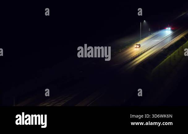 Car traveling through road in night, headlights lighting way. Vehicle ...