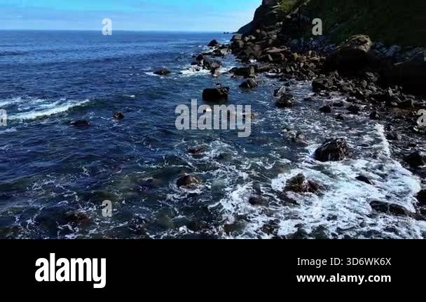Waves hitting rocky coast on North Sea shore in Scotland. Swells ...