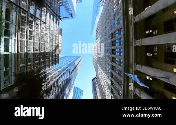 POV of upward view between tall skyscrapers in Chicago. The blue sky is ...
