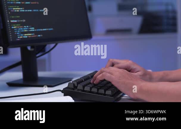 Close-up shot of IT freelancer programmer and tech engineer working with computer keyboard, hand ...