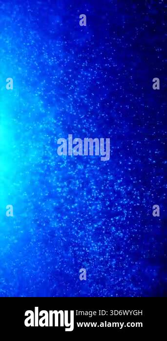 Small, glowing particles flow and gather within a dark blue liquid or ...