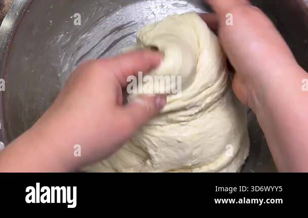 The process of folding and stretching raw yeast dough to make homemade ...