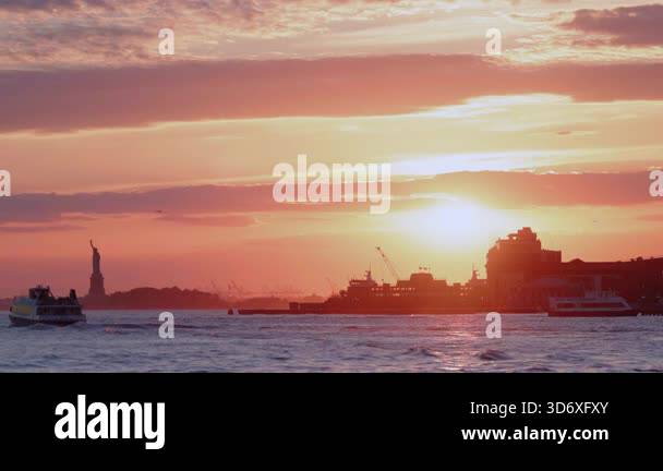 Scenic sunset over New York City, New York with glowing clouds, calm ...
