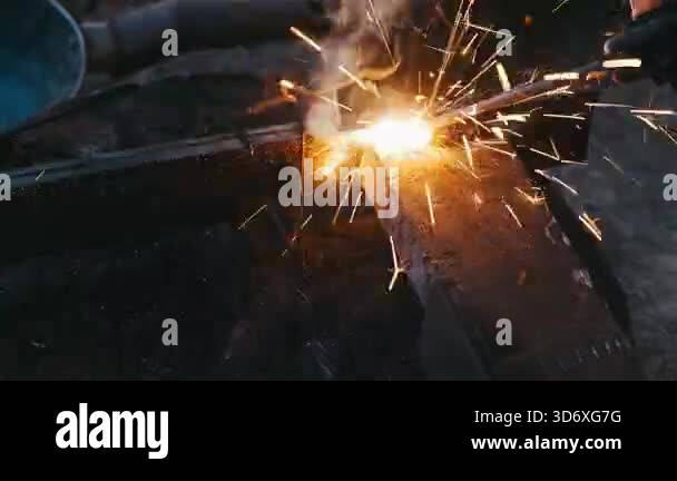 bright welding arc cutting steel, close-up of torch melting thick plate ...