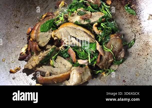 Cooking stir-fried roasted duck with basil, Thai famous food Stock ...