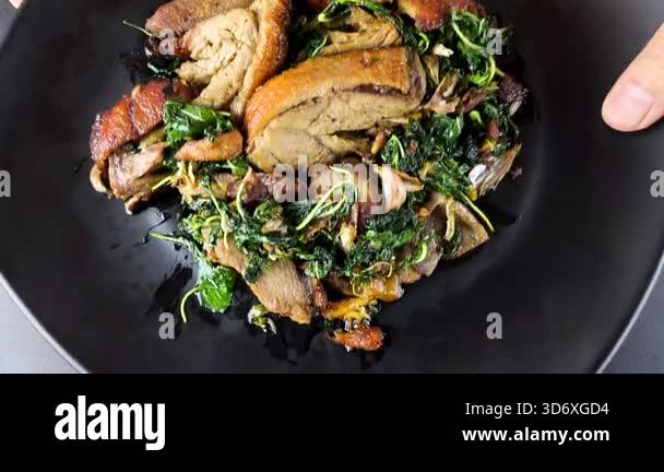 Stir-fried roasted duck with basil in plate, Thai famous food Stock ...