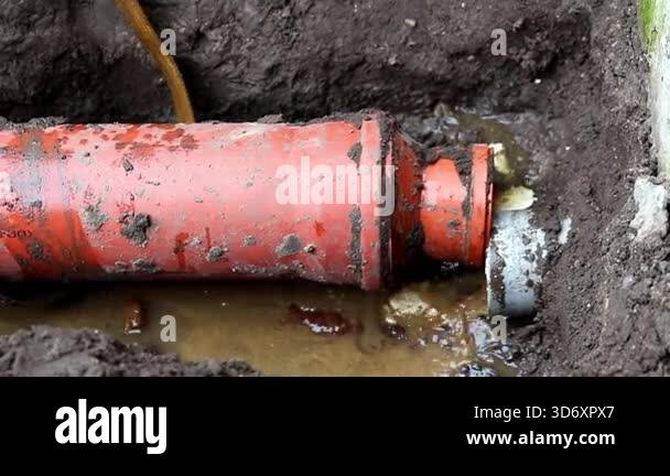 Close-up of Burst Sewer Pipe Emergency. Sewage and Wastewater Leak. a ...