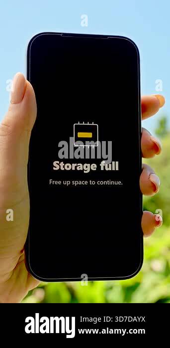 Vertical video. Hand Holding Smartphone with Storage Full Warning ...