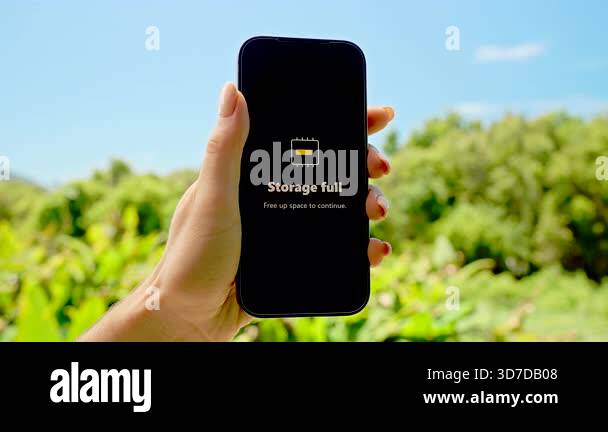Hand Holding Smartphone with Storage Full Warning Message Against Blue ...