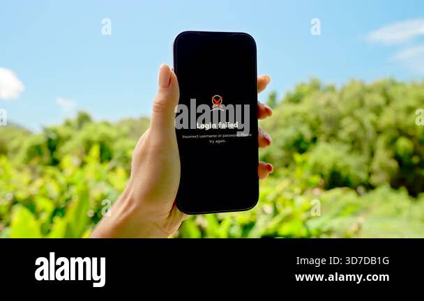 Smartphone in Hand Showing Login Failed Screen with Sunny Background of ...