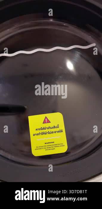 Vertical video. Closed Washing Machine Door with Reflection and Yellow ...