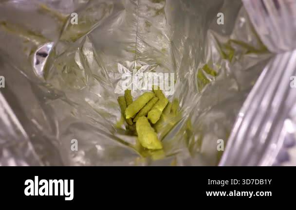 Hand Reaching into Almost Empty Snack Bag with Few Green Pieces Left at ...
