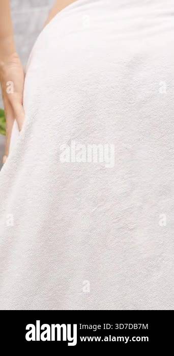 Vertical video. Woman Standing with Towel Wrapped Around Body After ...