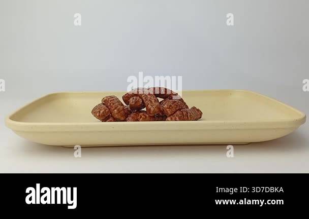 Hand pick up chocolate snacks on a square plate, isolated on white ...