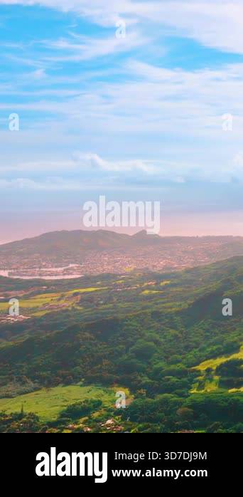 Dense forest and hills with town nestled between and ocean on horizon ...