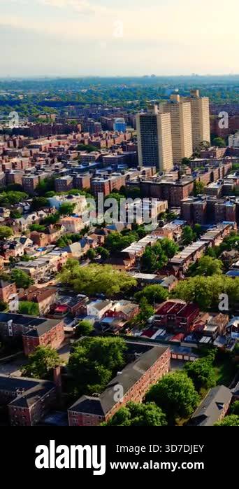 Low-rise homes and mid-rise buildings with two prominent beige towers ...