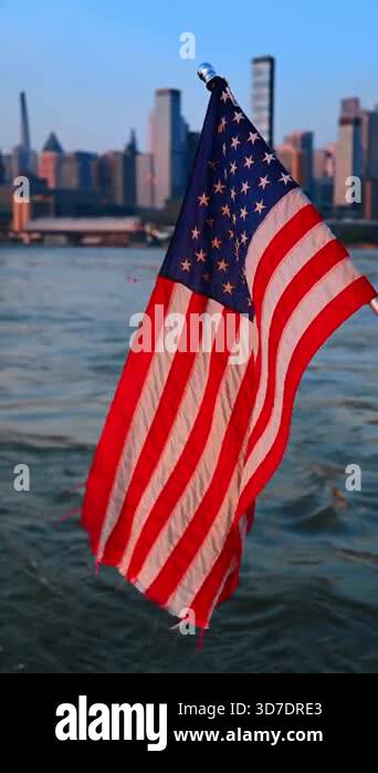 Flapping American flag in the light of sunset. Close up. Waterscape and ...