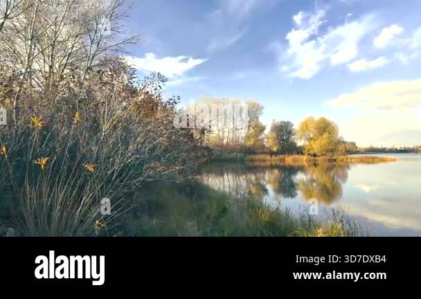 Beautiful autumn landscape with a lake and blue water. Retro-style ...