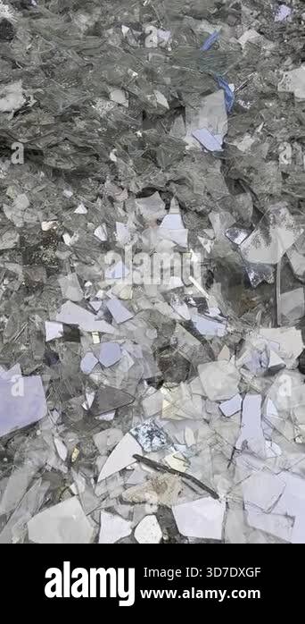 Scattered pile of shattered glass debris outdoors, closeup full-frame ...