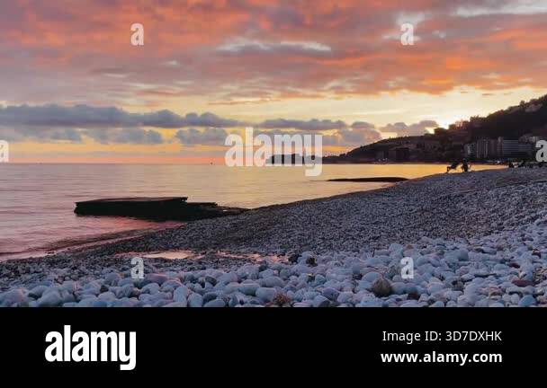 magenta sky pebble shore evening stroll, calm sea reflecting pastel ...