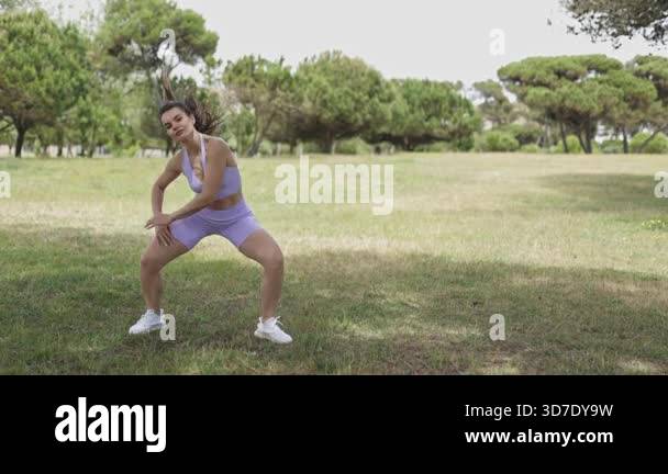 Young athletic woman in sportswear performing a dynamic and joyful ...