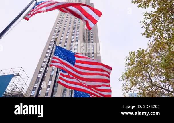 Strong wind waves American flags on the poles. Low angle view at the ...