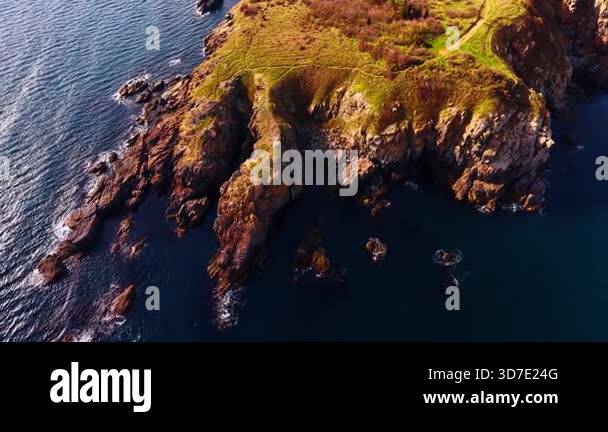 Rocky peninsula with deep coastal split. Sharp rugged outcrop divides ...