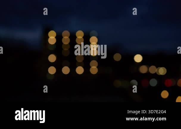 An abstract background with blurred car headlights at night and a soft ...